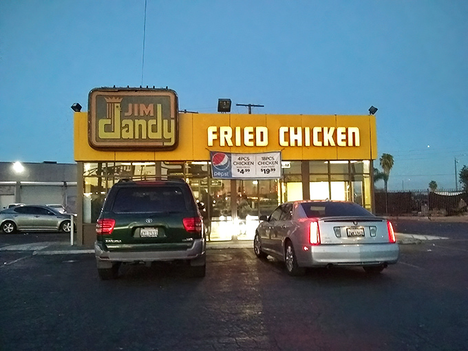 The unassuming yellow facade of Jim Dandy might not scream "culinary landmark," but that vintage sign has been guiding fried chicken pilgrims for decades.