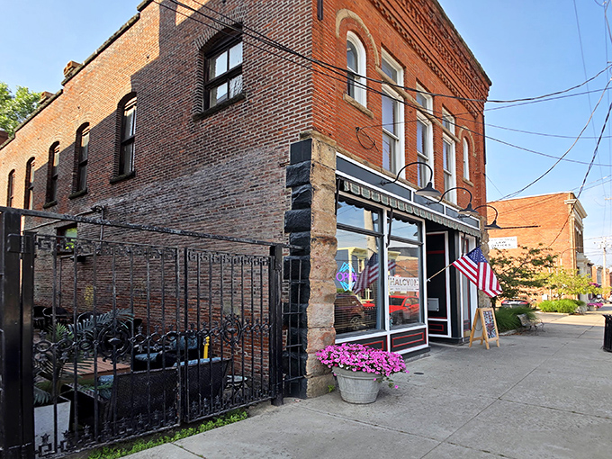 The historic brick fa&ccedil;ade of Harbor Halcyon welcomes visitors with classic charm and an American flag, promising culinary adventures in Ashtabula Harbor.