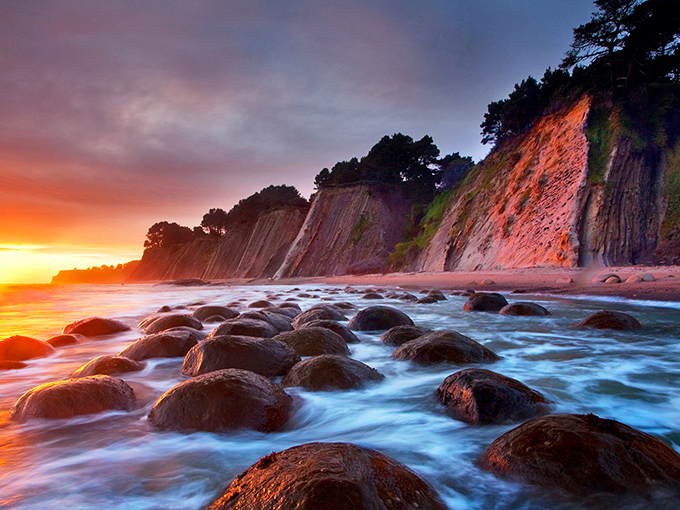 Nature's bowling alley at sunset. The Pacific's golden light transforms these ancient spherical rocks into a scene straight from a sci-fi masterpiece.