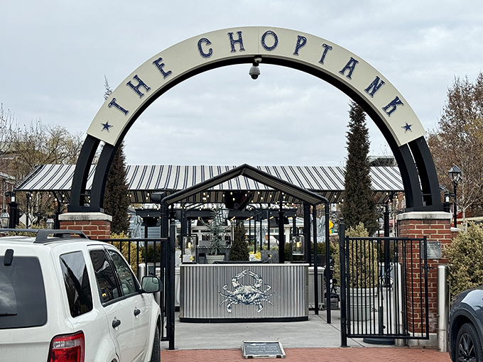 The grand entrance arch to The Choptank stands like a portal to seafood paradise, complete with that iconic Maryland blue crab emblem.