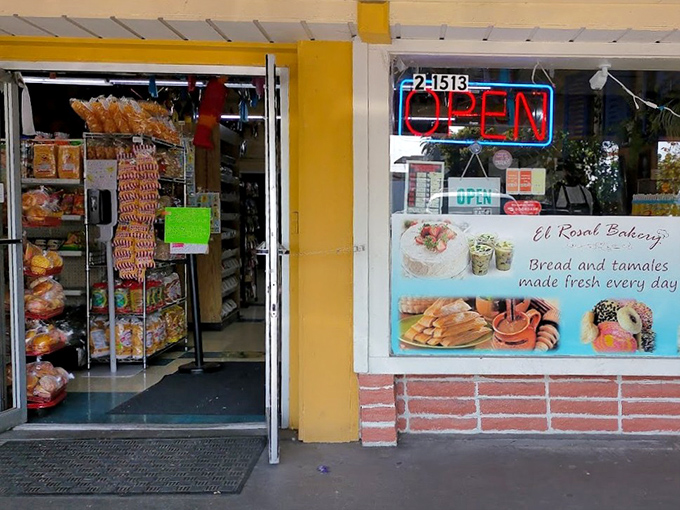 The unassuming storefront of El Rosal Bakery beckons with its blue-tiled roof and bright red sign—proof that culinary treasures often hide in plain sight.