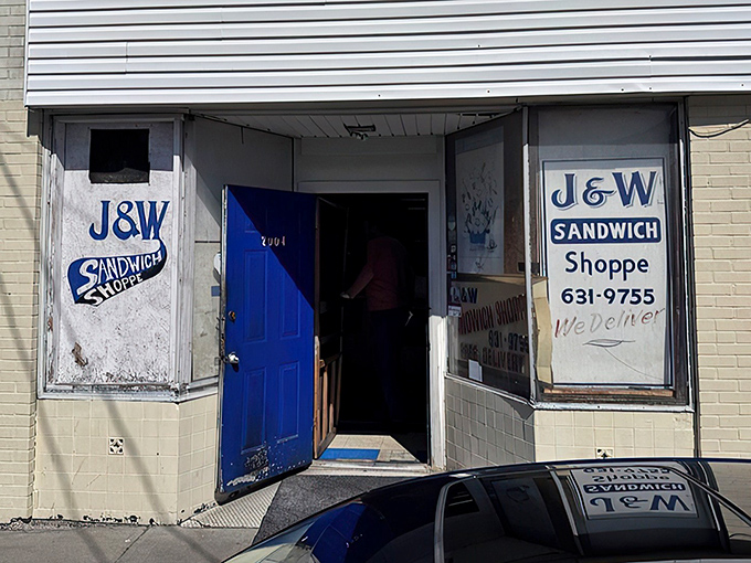 That blue door isn't just an entrance – it's a portal to sandwich nirvana, where J&W's humble exterior belies the flavor treasures waiting inside.