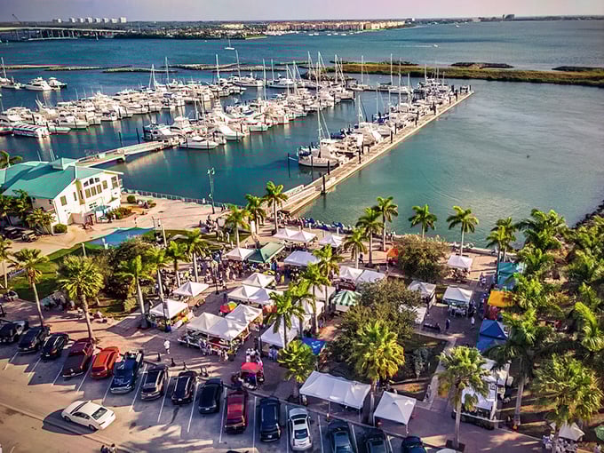 Sunset paints the sky gold over Fort Pierce Marina, where tiki-roofed restaurants promise seafood feasts and waterfront memories.