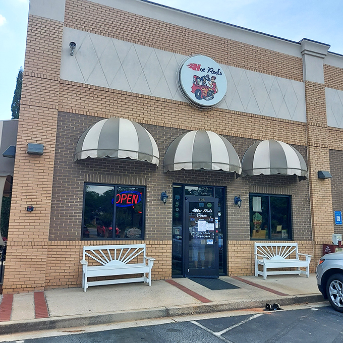 The classic brick exterior with striped awnings isn't just a restaurant&mdash;it's a time machine disguised as a diner in Social Circle, Georgia.
