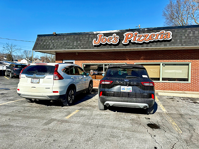 The unassuming brick exterior of Joe's Pizzeria might not win architectural awards, but the packed parking lot tells the real story.