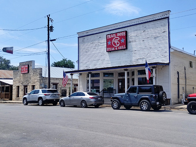 The neon-outlined Trail Boss sign glows like a beacon for hungry travelers. This unassuming exterior houses culinary treasures that would make any cowboy weep with joy. 