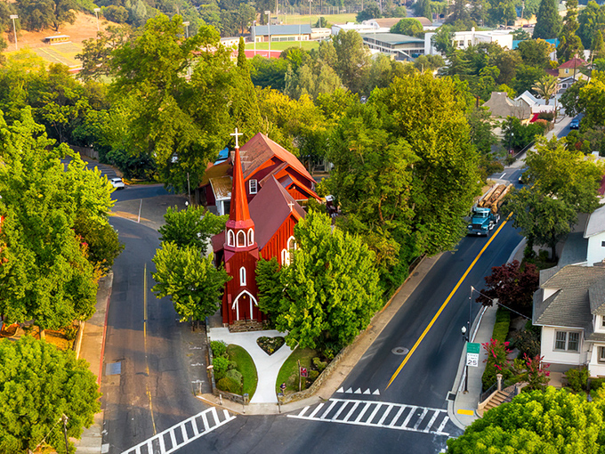 The iconic red church stands like a crimson exclamation point amid Sonora's lush greenery, a postcard-perfect scene that whispers "small-town charm" at full volume.