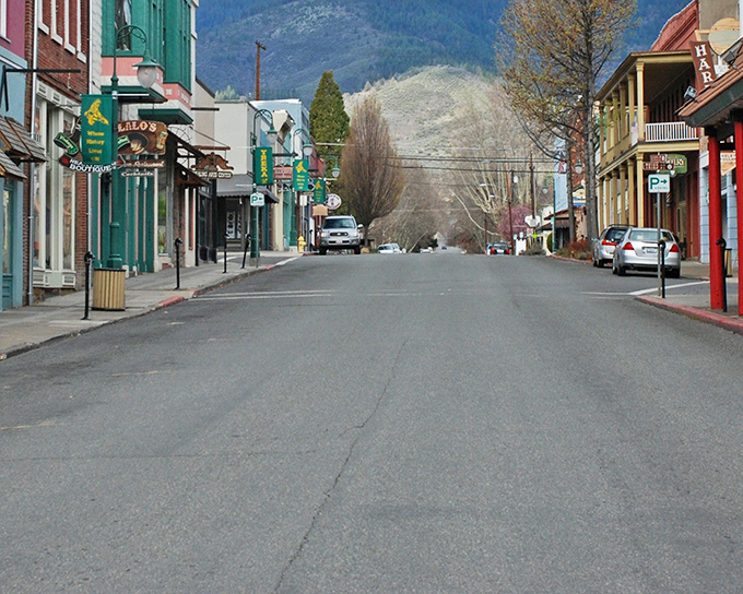 Miner Street stretches into the distance, framed by colorful historic buildings and mountain views. Small-town charm doesn't get more picture-perfect than this.