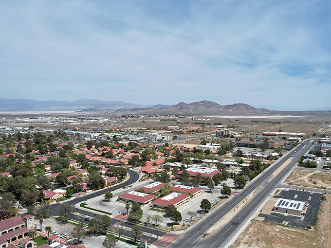 Ridgecrest sprawls beneath vast desert skies, where red-roofed homes dot the landscape like terracotta islands in a sea of sage and sand.