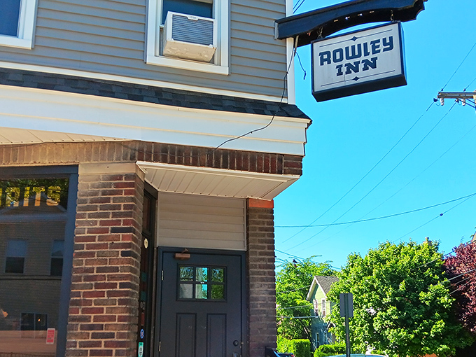 The unassuming exterior of The Rowley Inn stands like Cleveland's best-kept secret, a blue-gray beacon of culinary delight in Tremont's historic landscape.