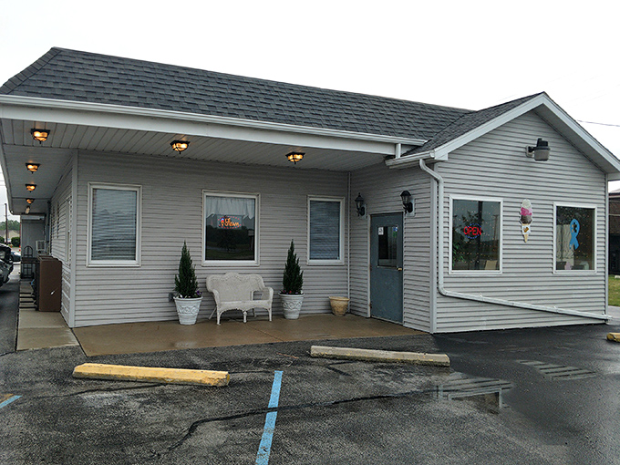 The unassuming exterior of Granny's Kitchen stands like a culinary secret waiting to be discovered. Simple gray siding, a few potted plants, and zero pretension.