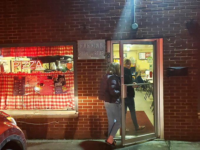 The neon glow of Rubino's storefront beckons like a lighthouse for pizza pilgrims. This brick facade has witnessed decades of hungry Ohioans making their pizza pilgrimages.