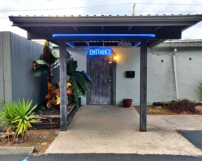 That blue neon "ENTRANCE" sign isn't just an invitation&mdash;it's a portal to steak paradise hiding behind an unassuming Florida facade.