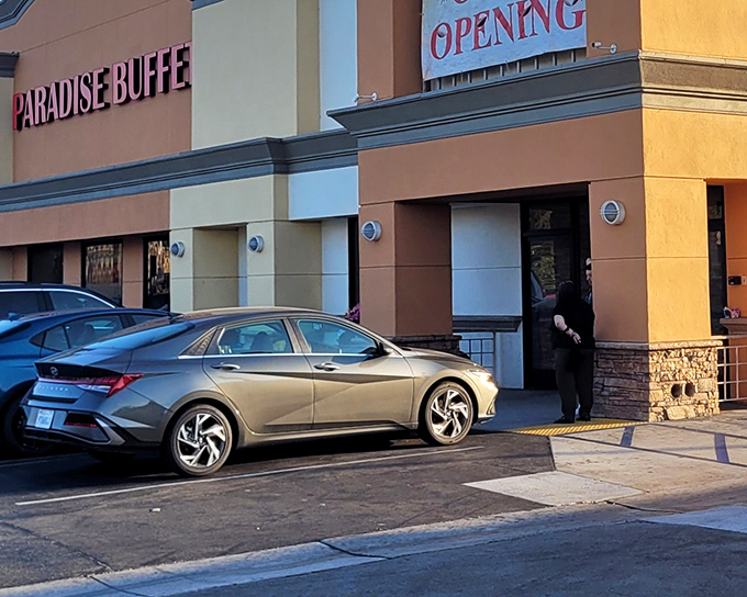 The bright red letters of Paradise Buffet stand out like a culinary lighthouse, guiding hungry travelers to this Montebello feast-haven.