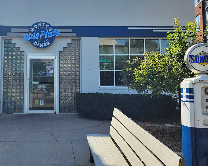 The blue neon sign beckons like a lighthouse for hungry souls. This converted gas station now fuels Madison residents with comfort food rather than automobiles.