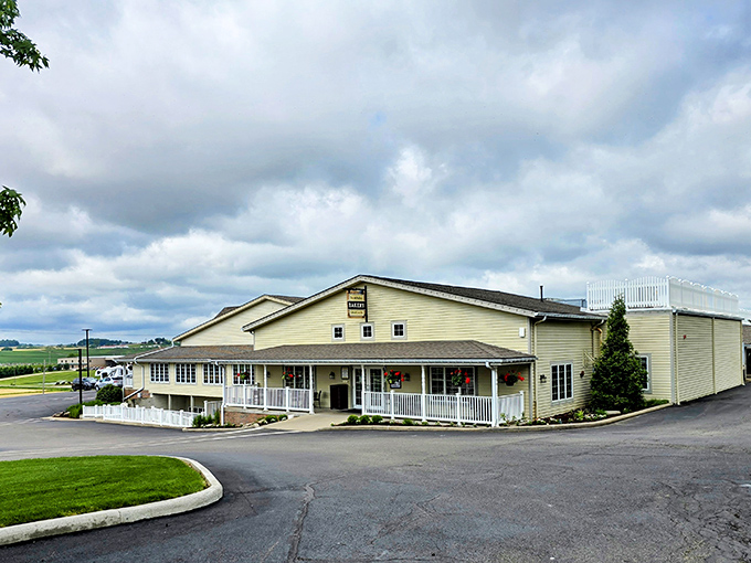 The welcoming facade of Dutch Valley Restaurant stands like a beacon of comfort food in Sugarcreek, complete with rocking-chair-ready porch and hanging flower baskets.