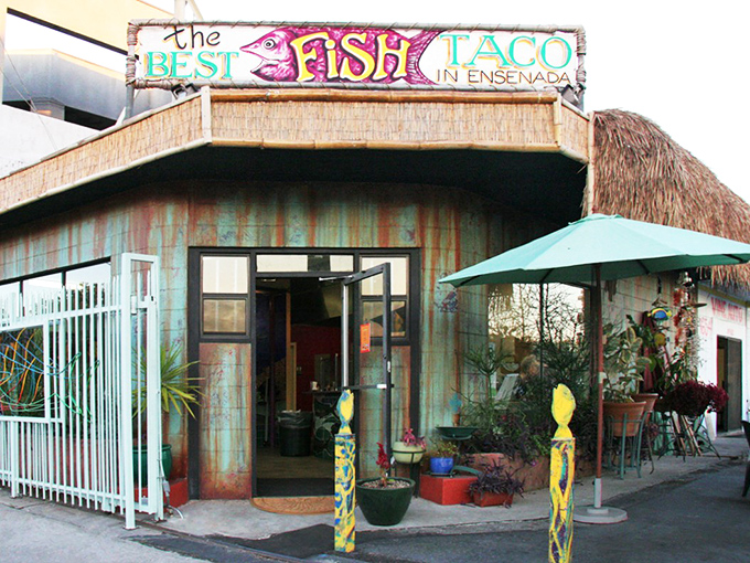 The weathered turquoise exterior isn't trying to impress anyone—it's saving all its energy for what happens inside those doors. Beach shack vibes in the heart of Los Feliz.