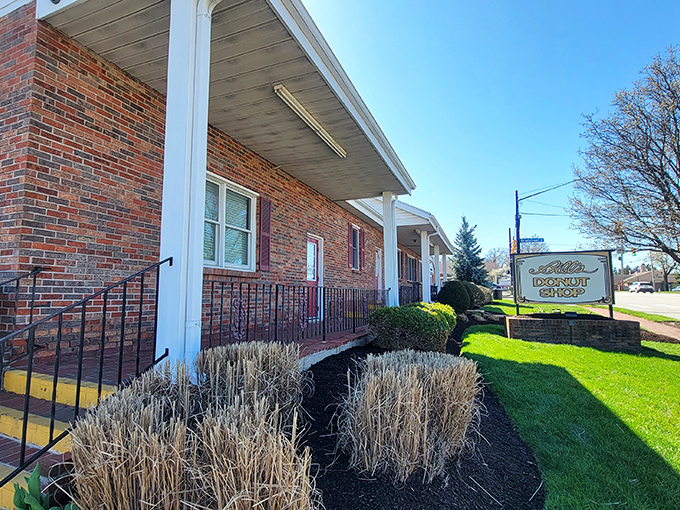The brick facade whispers promises of sweet treasures waiting inside this beloved neighborhood institution.