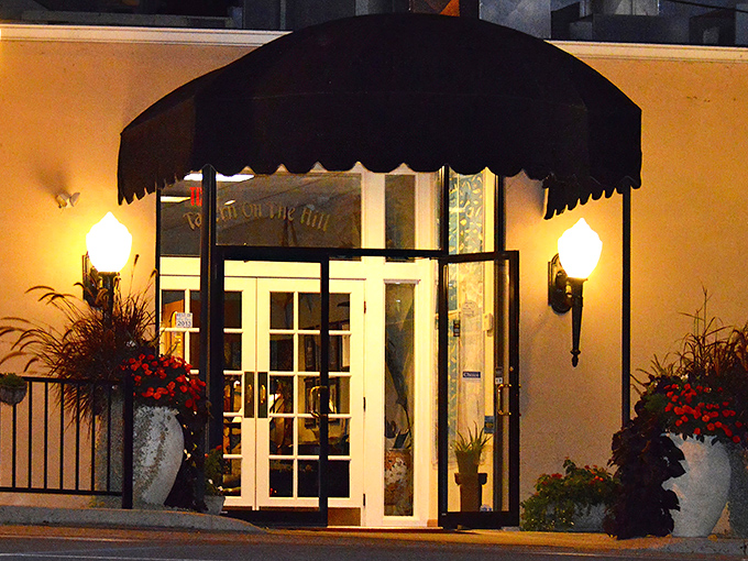 The entrance to Tavern on the Hill beckons like a culinary lighthouse, its elegant awning and warm glow promising delicious refuge from everyday dining disappointments.