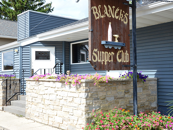 Blue-sided and unassuming, Blanck's Supper Club stands like a culinary lighthouse in Malone, beckoning hungry travelers with colorful flower boxes and the promise of Wisconsin hospitality.