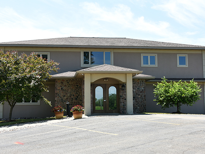 The stone-accented entrance to Cimaroli's stands like a culinary fortress, promising Midwest hospitality and prime rib treasures within those double doors.