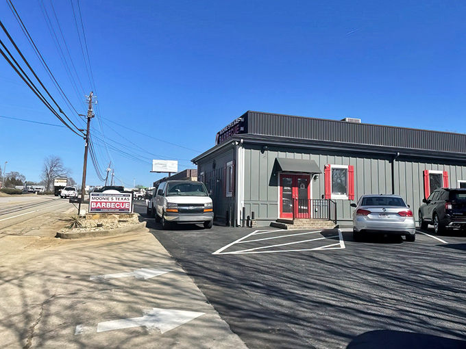 The unassuming exterior of Moonie's Texas BBQ stands like a smoke-scented beacon of hope for hungry travelers. That American flag isn't just decoration&mdash;it's a promise of patriotic flavor.