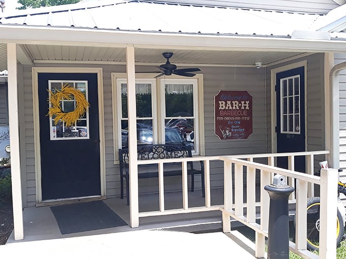 The unassuming entrance to Bar-H Barbecue proves once again that in the South, the most modest porches often hide the most magnificent flavors.