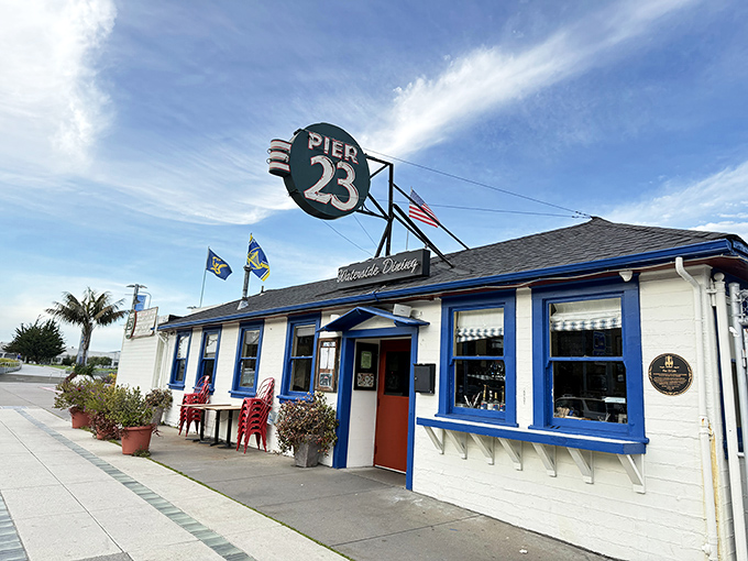 The iconic blue-trimmed exterior of Pier 23 Cafe stands like a maritime postcard come to life, beckoning hungry travelers with its classic San Francisco waterfront charm.