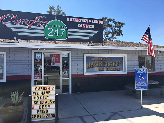 The unassuming exterior of Cafe 247 stands like a culinary mirage in the desert, complete with an alien mascot who clearly knows where the good food is.