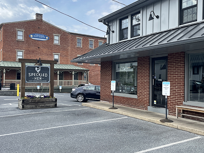 The brick exterior of Speckled Hen welcomes you like an old friend, with its cheerful yellow flowers and rustic wooden sign promising delicious possibilities within.