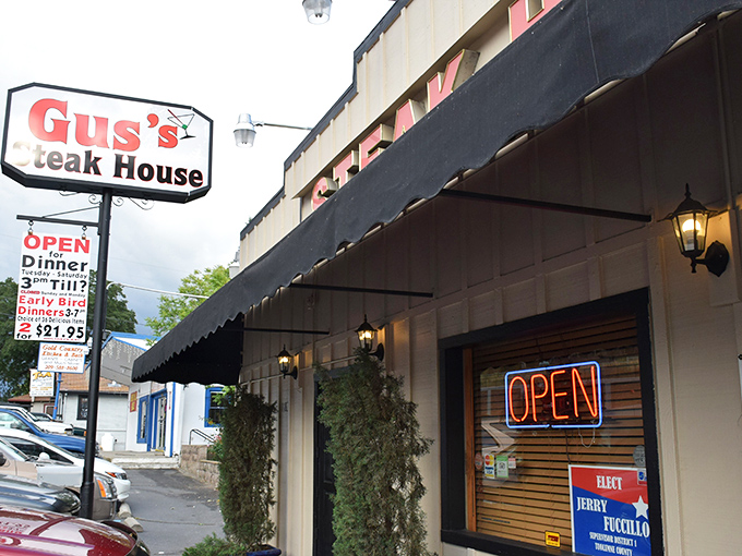 The neon glow of Gus's Steakhouse beckons hungry travelers like a carnivorous lighthouse in the Sierra foothills. Steak salvation awaits inside.