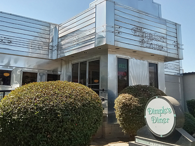 The gleaming Art Deco exterior of Dimples Diner stands like a chrome-plated time machine, promising breakfast dreams come true inside.