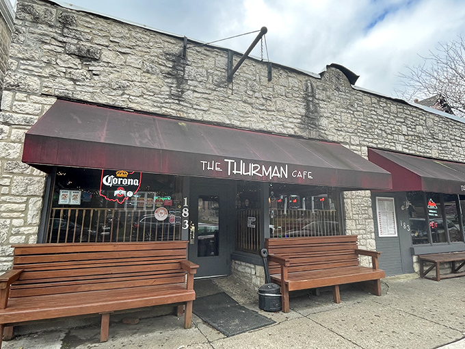 The unassuming stone exterior of Thurman Cafe belies the culinary madness within. Those wooden benches? They're not decorative&mdash;they're survival gear for the wait.