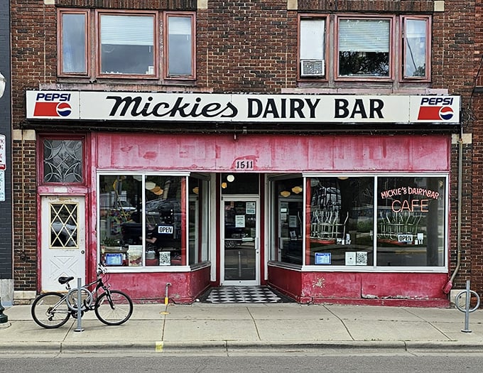 The iconic pink facade of Mickey's Dairy Bar stands as a time capsule of Americana, beckoning hungry visitors with retro charm that Instagram filters try desperately to replicate.