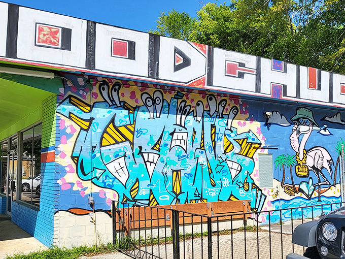 The vibrant blue exterior and eye-catching mural of Woodchuck's Cafe stands out like a beacon of breakfast hope in Tallahassee's morning landscape.