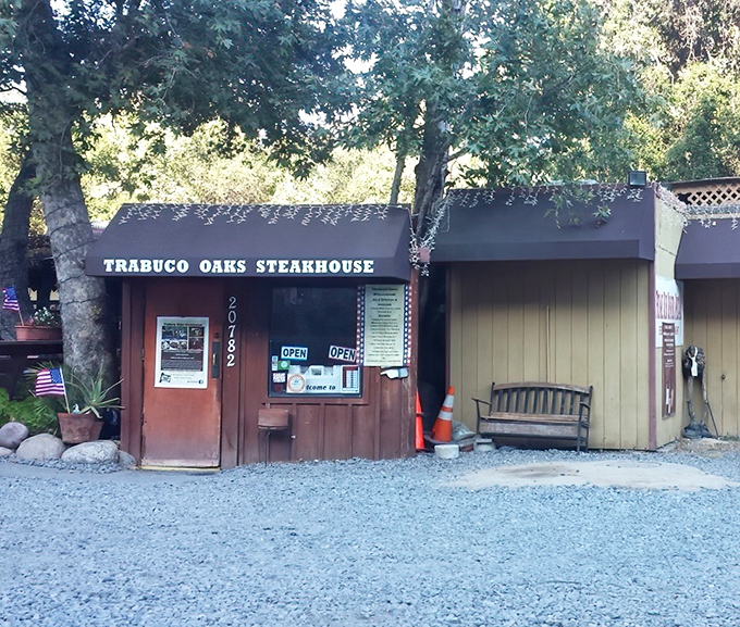 The unassuming exterior of Trabuco Oaks Steakhouse proves once again that the best culinary treasures often hide in plain sight, nestled among California oaks.