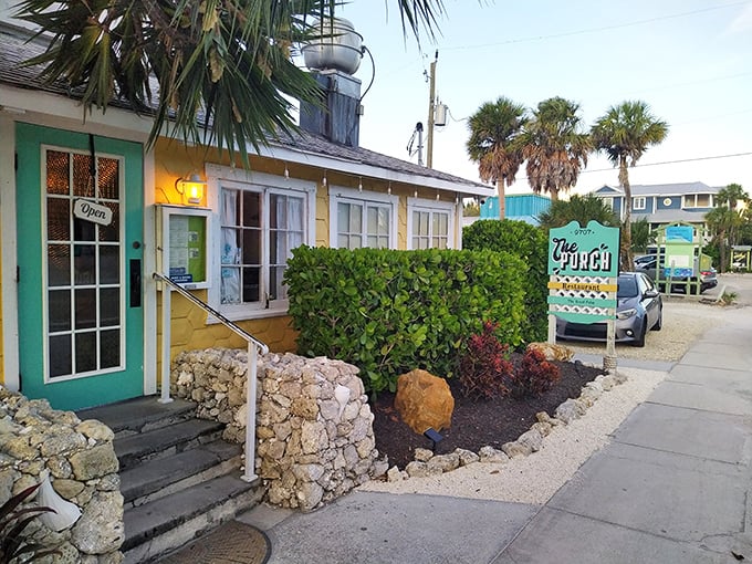 The cheerful yellow cottage with its mint-green door stands like a tropical beacon under Florida's impossibly blue sky.