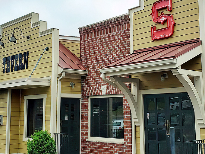 The iconic facade of Silver Spring Mining Company beckons hungry travelers with its distinctive "TAVERN" sign and bold red "S" logo, promising comfort and satisfaction within.
