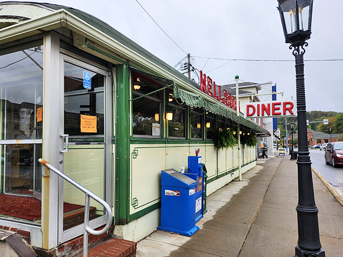 The mint-green exterior of Wellsboro Diner stands like a time capsule on wheels, complete with vintage signage and lovingly maintained landscaping.