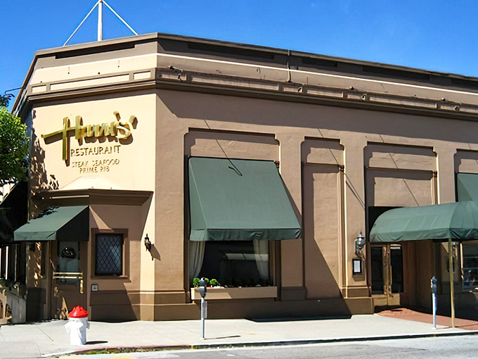 The classic cream exterior with forest green awnings says "serious steak business happens here" before you even walk through the door.
