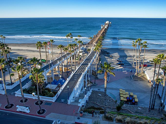 This is perfection at Oceanside Pier, where palm trees stand like nature's exclamation points against the golden horizon. This wooden wonder stretches nearly 2,000 feet into the Pacific.