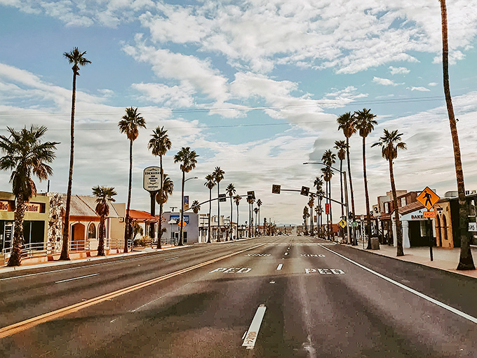 Palm trees stand like sentinels along Twentynine Palms Highway, where the desert sky puts on a better show than any streaming service you've subscribed to.