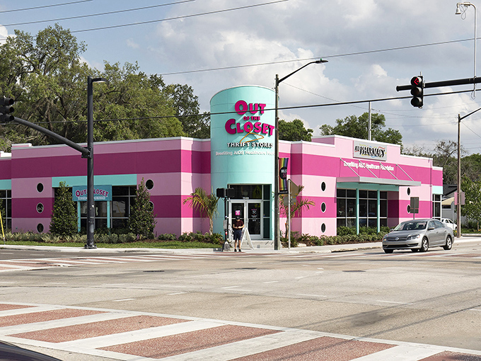 The unmistakable pink and turquoise facade of Out of the Closet stands out like a flamingo in a penguin convention, beckoning bargain hunters with its vibrant charm.