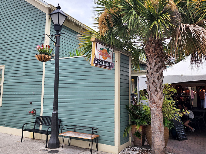 The seafoam-green exterior of The Floridian stands like a culinary lighthouse in St. Augustine's historic district, beckoning hungry travelers with Southern charm.