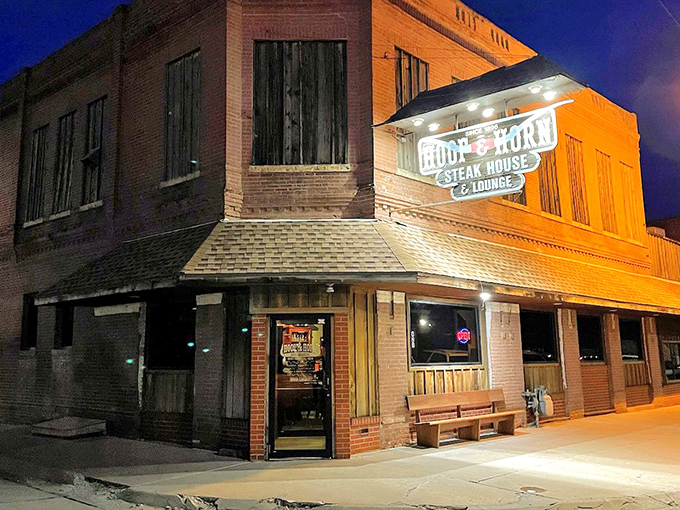The historic brick exterior of Hoof & Horn stands like a time capsule at a crossroads, promising carnivorous delights within its weathered walls.