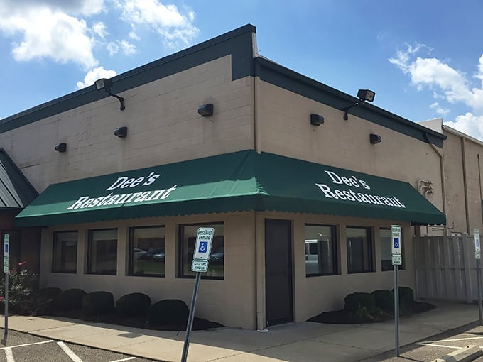 The unassuming exterior of Dee's Restaurant, with its signature green awnings, proves that culinary treasures often hide in plain sight.