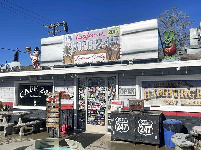 The unassuming exterior of Cafe 247 stands like a culinary mirage in the desert, complete with an alien mascot who clearly knows where the good food is.