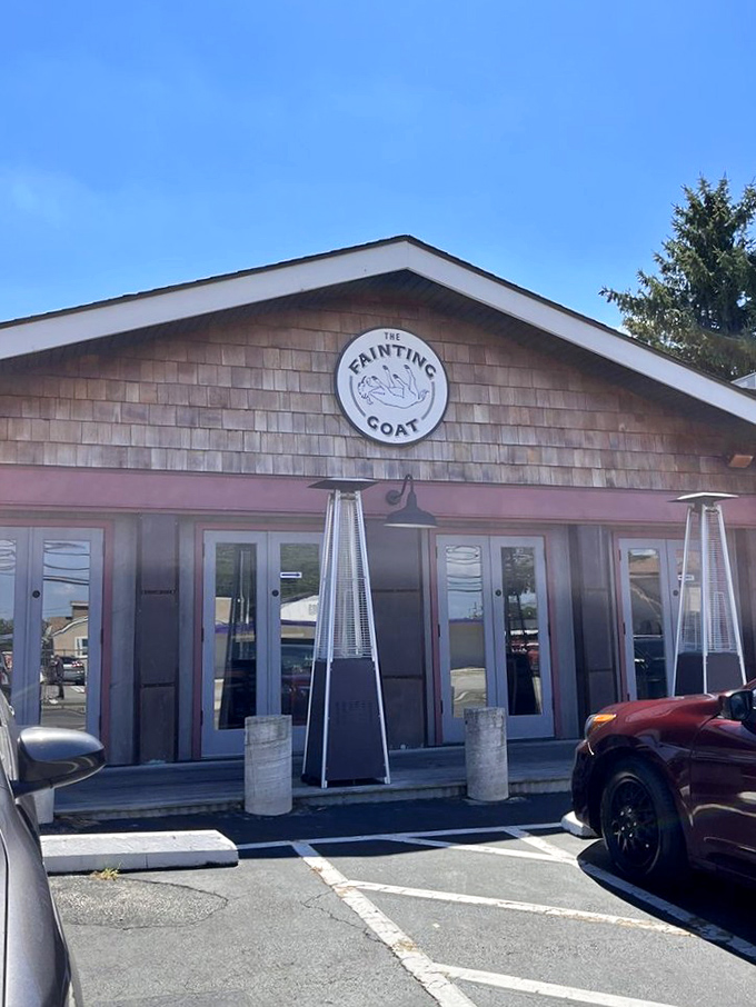 Sunset creates magic over The Fainting Goat's inviting exterior. String lights twinkle with promise while picnic tables await diners seeking that perfect Pennsylvania evening vibe.