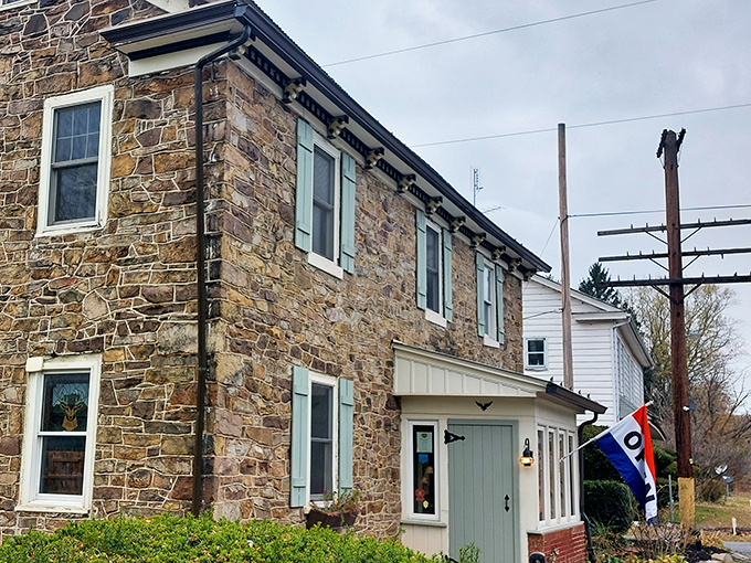 Stone walls that have witnessed centuries of American history stand proudly under a metal roof, with pale blue shutters adding colonial charm to this riverside treasure.