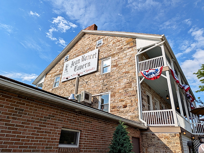 Stone walls that have witnessed centuries of American history stand proudly under Pennsylvania skies, adorned with patriotic bunting that seems to whisper, "George Washington slept here."